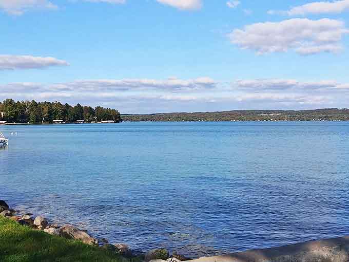 Morning calm settles over Torch Lake's shoreline, that magical hour when the water mirrors the sky and coffee tastes better outdoors.