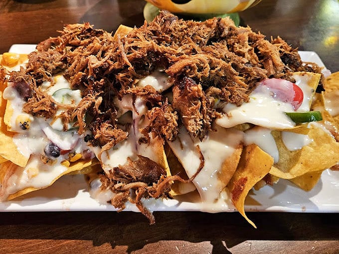 Nachos that refuse to be ordinary—loaded with pulled pork and enough cheese to make Wisconsin nervous.