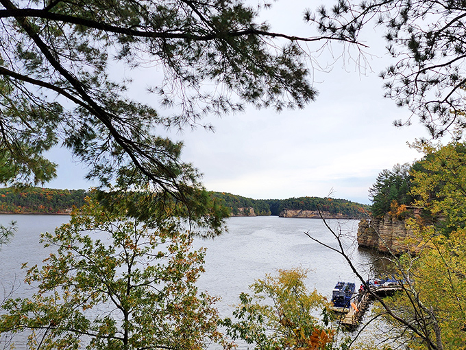 The Wisconsin River stretches into the distance, flanked by ancient cliffs and autumn-touched trees. This view has inspired generations of painters, photographers, and daydreamers.