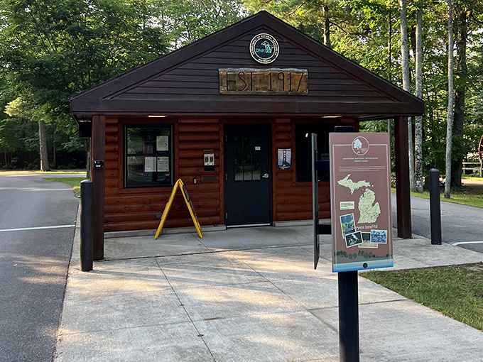 The rustic ranger station welcomes visitors with charm and information. First stop on your adventure into Michigan's oldest state park!