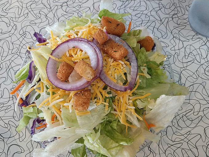 Even the greens get the classic treatment&mdash;crisp lettuce, shredded cheese, and those perfect red onion rings that add just enough bite.