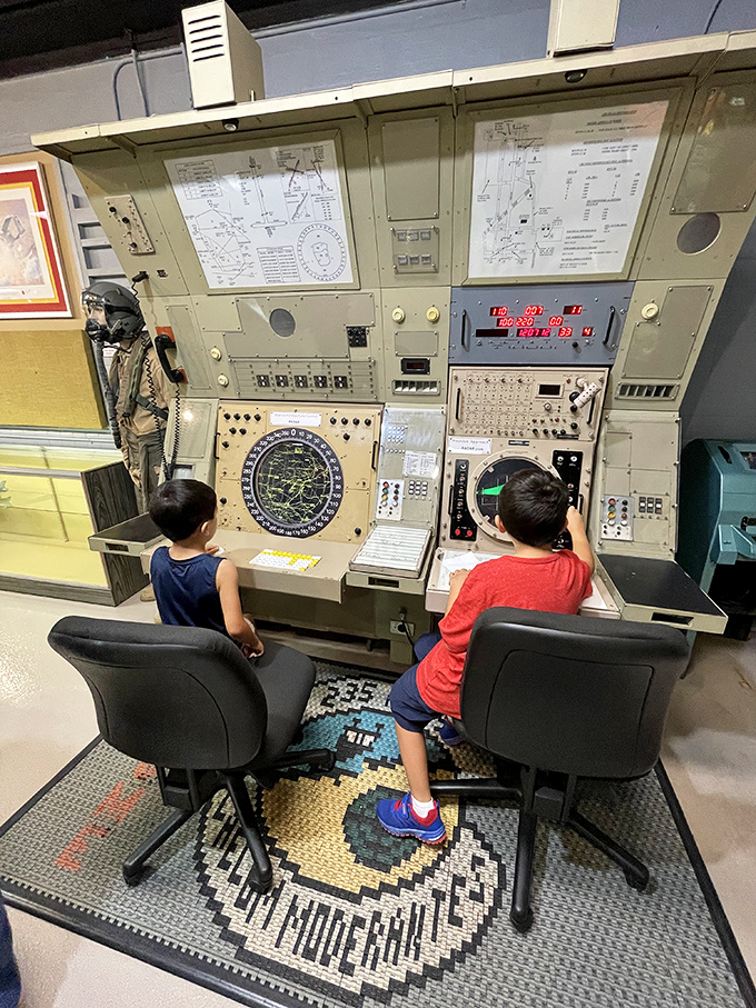 Young aviators test their skills at vintage control panels, their imaginations soaring far beyond the museum walls into virtual skies of possibility.