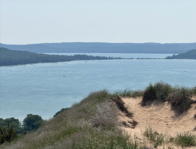 The vast expanse of Glen Lake shimmers like liquid sapphire, cradled by the protective embrace of surrounding hills.