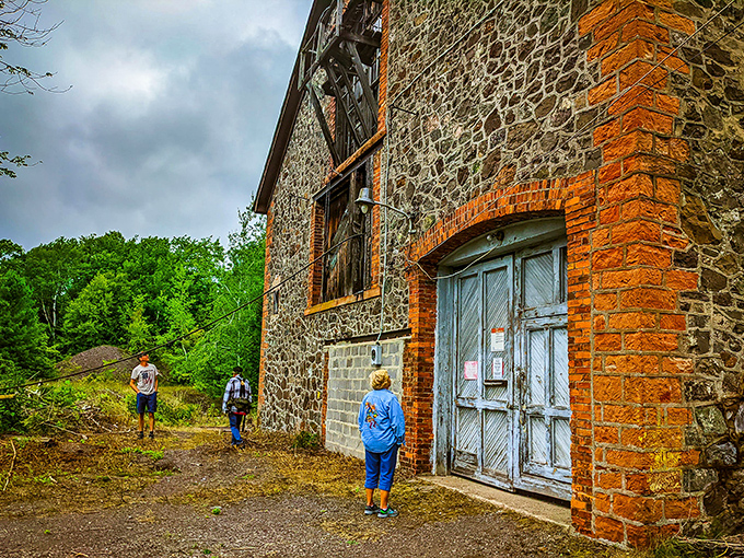 Visitors explore the stone buildings, their scale providing perspective on just how massive this industrial operation once was in rural Michigan.