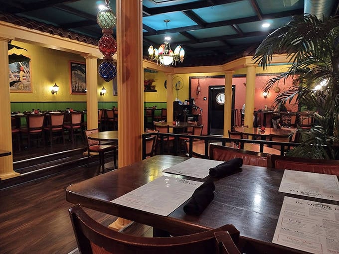 Warm wooden beams and globe pendant lights create the perfect atmosphere for savoring comfort food classics in this cozy dining room.