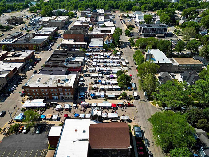 From above, the market sprawls across downtown Morris like a patchwork quilt of white tents, each square holding its own delicious secrets and vintage surprises.