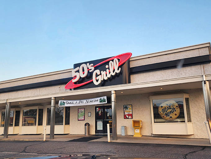 The iconic red neon sign of 50's Grill beckons hungry time-travelers with promises of nostalgic comfort and classic American fare.