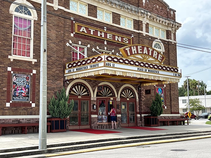 The iconic brick façade of Athens Theatre stands proudly in DeLand, its vintage marquee glowing with promise of entertainment that transcends generations.