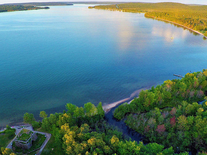 Aerial splendor of Bay Furnace Campground, where Lake Superior's azure waters meet the emerald embrace of Michigan's forests &ndash; nature's perfect marriage.