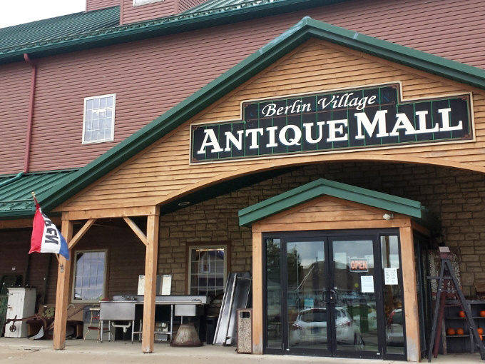 The Berlin Village Antique Mall's rustic exterior welcomes treasure hunters to Ohio's Amish Country, promising adventures in time travel without the flux capacitor.