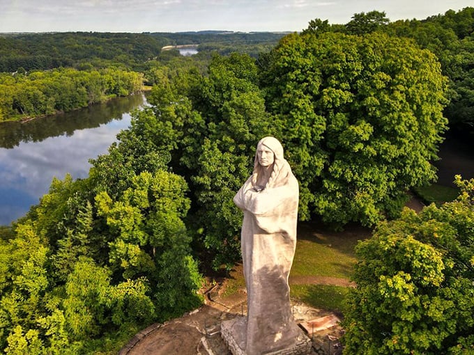 The Black Hawk Statue stands majestically above the Rock River, a concrete sentinel watching over the lush Illinois landscape with timeless dignity.