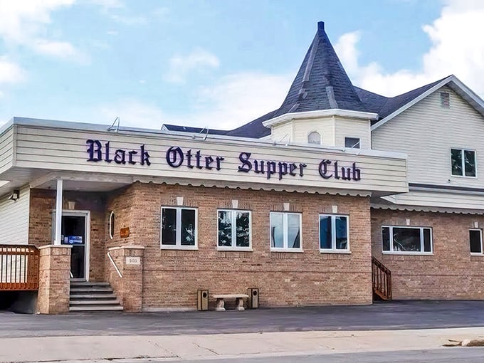 The iconic Black Otter Supper Club exterior welcomes hungry visitors with its charming turret and classic brick facade.