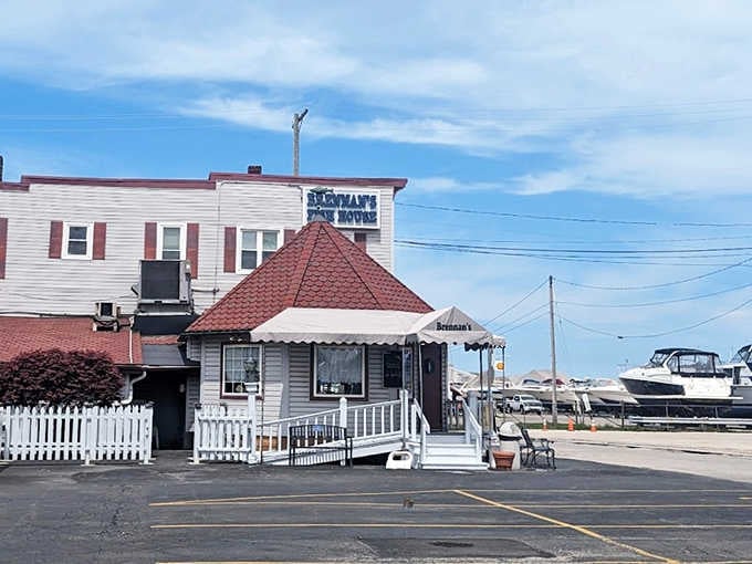 Brennan's Fish House exterior beckons with its charming white clapboard, distinctive red roof, and that irresistible "come on in" vibe.