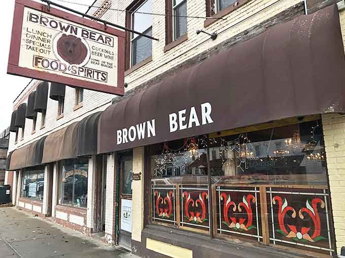 The iconic Brown Bear sign welcomes hungry travelers to Shelby's beloved burger haven, promising hearty meals and hometown charm beneath its weathered facade.