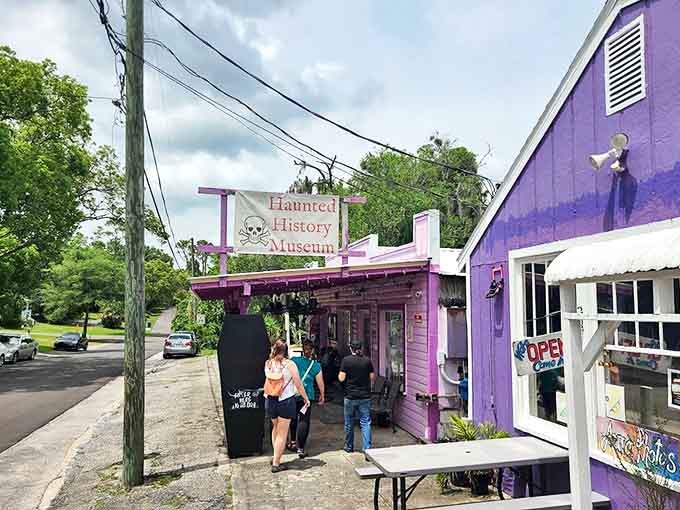 The vibrant purple exterior of C. Green's Haunted History Museum stands out in Cassadaga, beckoning brave souls with its skull-adorned sign and mysterious charm.