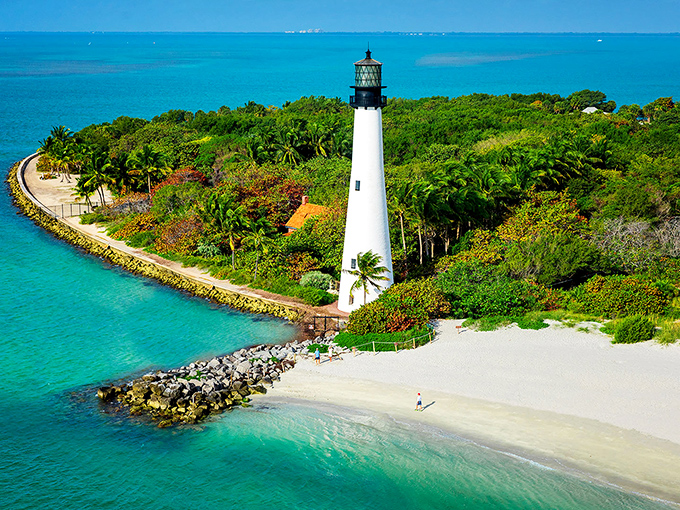The Cape Florida Lighthouse stands majestically against turquoise waters, like a pristine white exclamation point on Miami's southern coastline.