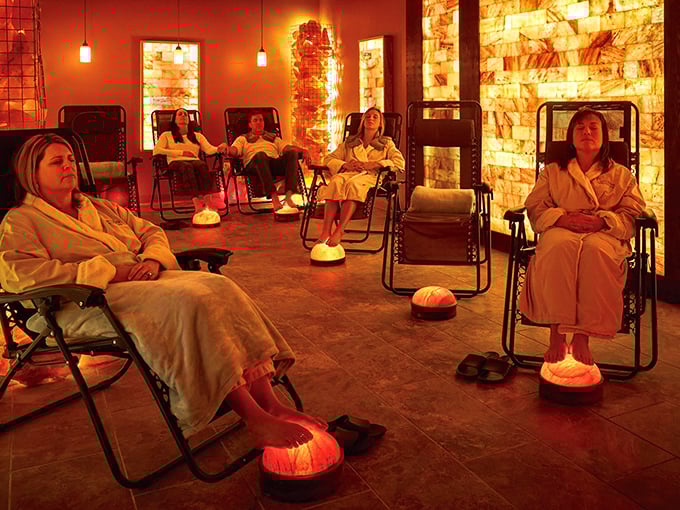 The warm amber glow of Himalayan salt walls creates an otherworldly atmosphere in Corcova's main halotherapy room.