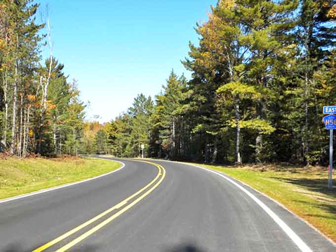 County Road H-58 winds through Michigan's Upper Peninsula like a ribbon of adventure, promising views that'll make your Instagram followers green with envy.