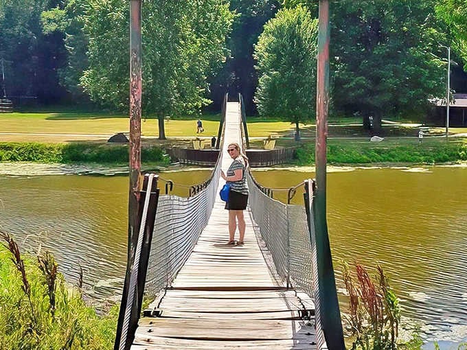 The Croswell Swinging Bridge stretches 139 feet across the Black River, inviting brave souls to experience its legendary sway with every step.