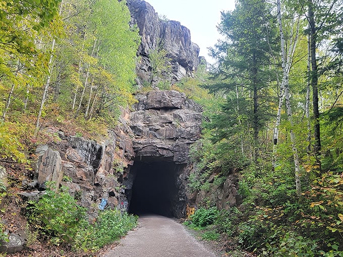 Nature's grand entrance: The DWP Trail tunnel beckons adventurers into its cool, mysterious embrace, framed by vibrant Minnesota greenery.
