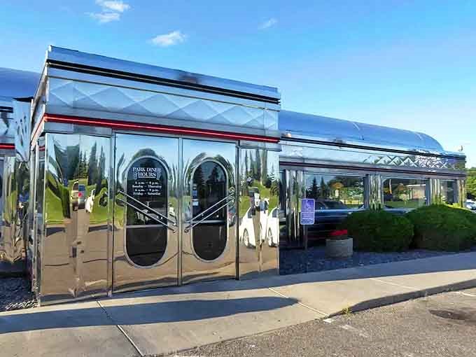The gleaming chrome exterior of Park Diner catches sunlight like a beacon of nostalgia, promising a time-travel experience with your meal.