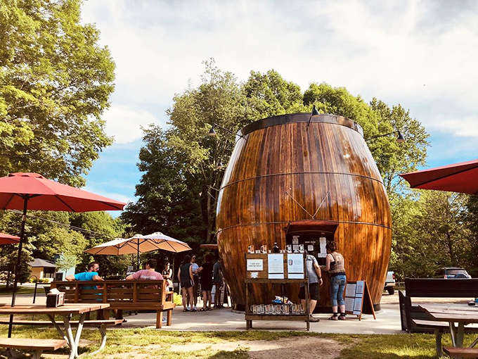 The Douglas Root Beer Barrel stands proudly among the trees, its wooden structure gleaming in the Michigan sunshine like a beacon for hungry travelers.