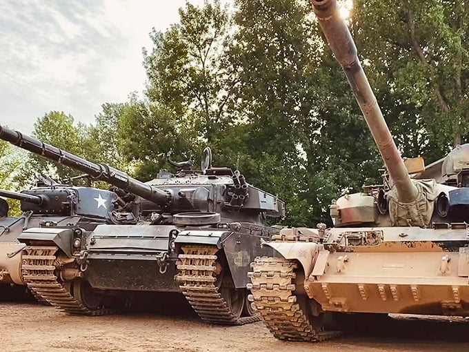Mechanical beasts at rest: British and American tanks line up, their massive cannons pointing skyward, awaiting their next civilian commander.