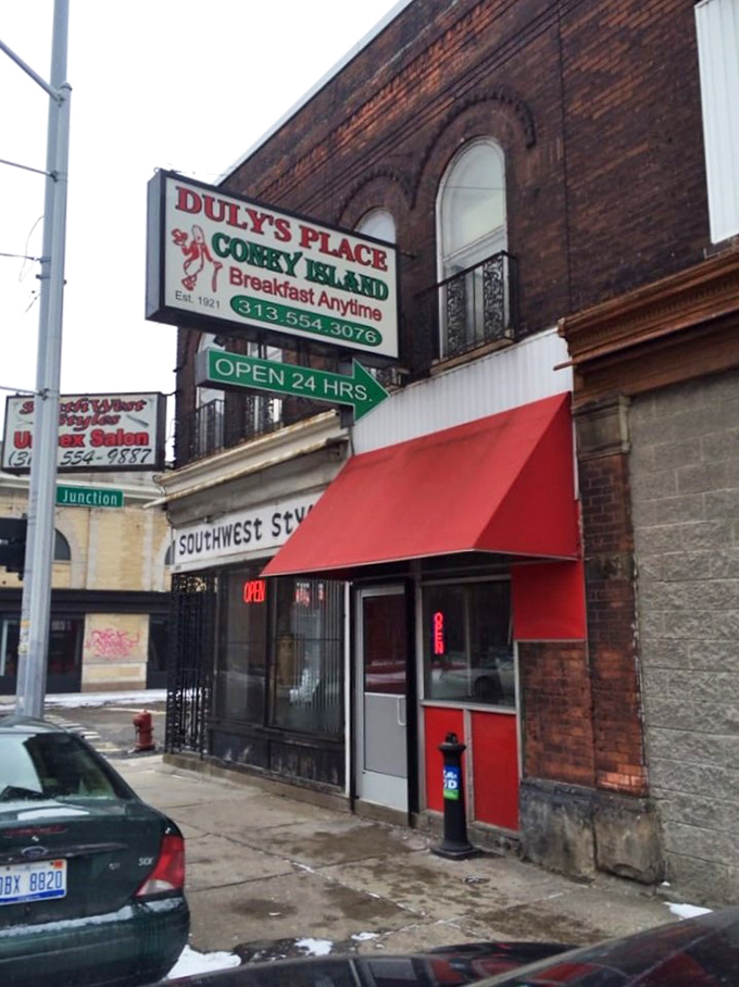 The iconic Duly's Place sign beckons hungry Detroiters 24/7, a red-awninged beacon of hope for Coney dog enthusiasts since 1921.