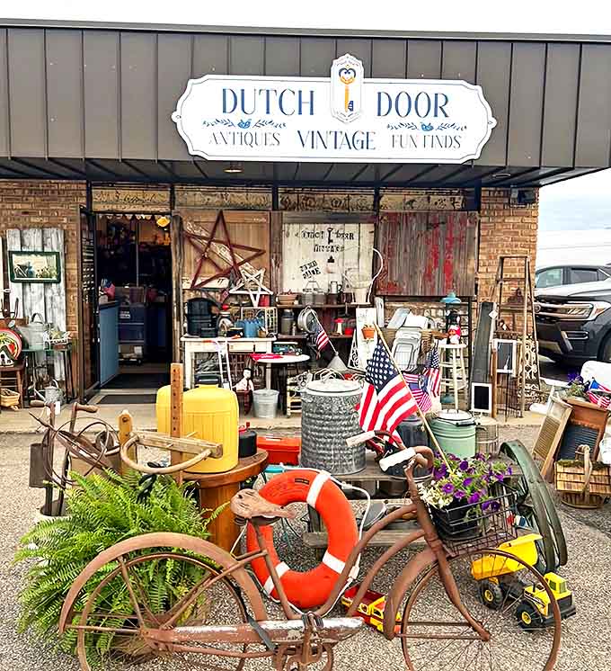 The inviting storefront of Dutch Door Antiques beckons with rustic charm and treasures spilling onto the sidewalk, promising adventures in vintage hunting.