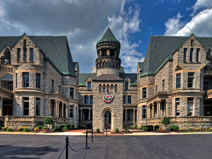 The imposing limestone facade of Ohio State Reformatory stands like a medieval castle, its turrets and towers promising stories darker than any fairy tale.