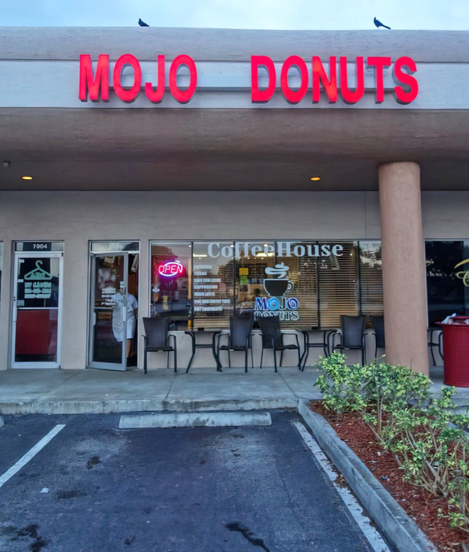 The iconic red Mojo Donuts sign beckons sweet-toothed adventurers to this unassuming strip mall location &ndash; Florida's temple of fried dough innovation.