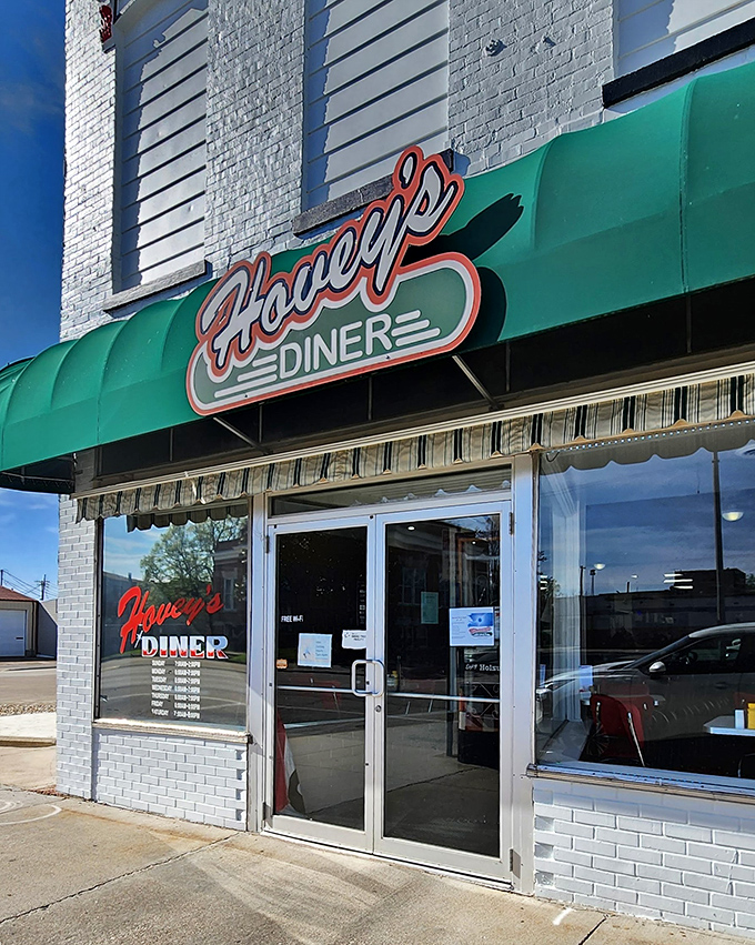 Hovey's iconic green awning and vintage signage welcome hungry travelers like a beacon of comfort food hope on Main Street.