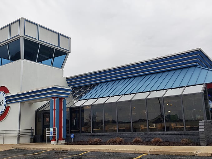 The distinctive exterior of B52 Bombers stands ready for takeoff, its blue roof and control tower design beckoning hungry travelers.