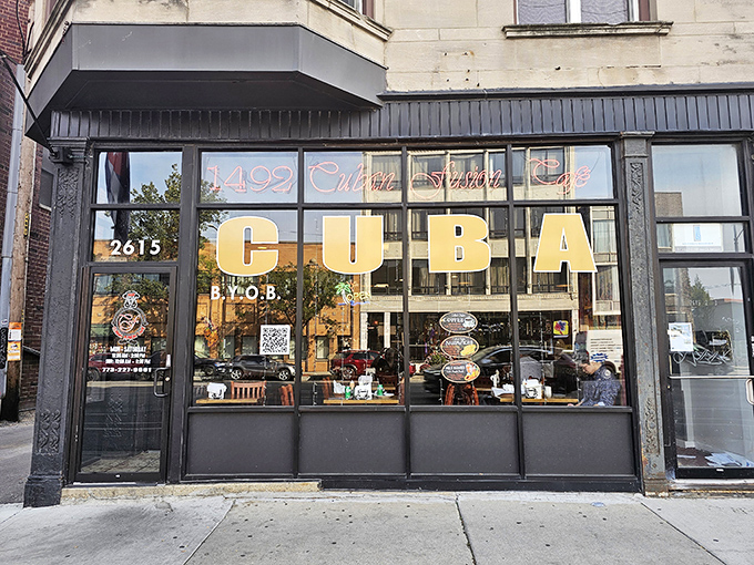 Bold gold lettering announces "CUBA" against dark windows, promising authentic flavors that transport you straight to Havana's vibrant streets.