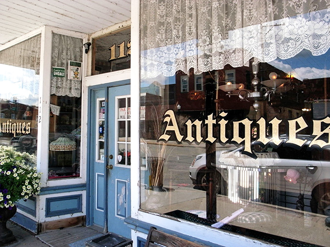 A blue door beckons with golden promise – Paraphernalia's charming storefront invites curious souls to step back in time and discover forgotten treasures.