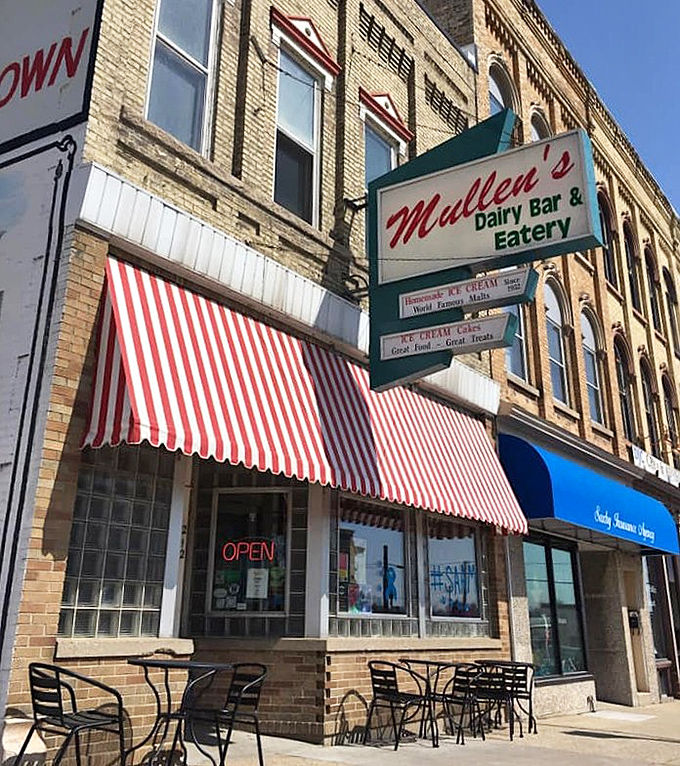 The iconic red and white awning of Mullen's Dairy Bar beckons from downtown Watertown, promising sweet nostalgia and homemade treats.