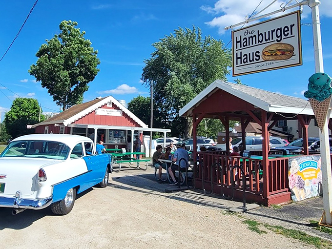 Classic Americana comes alive at The Hamburger Haus, where vintage cars and hungry patrons create a timeless summer tableau.