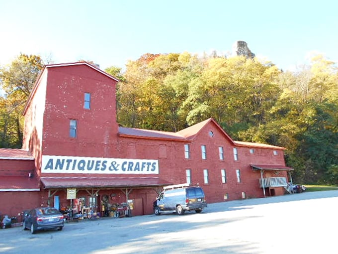 The iconic red brick exterior of Treasures Under Sugar Loaf stands like a monument to nostalgia against Winona's scenic backdrop.
