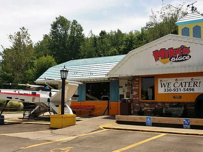 Mike's Place exterior welcomes adventurous diners with its unmistakable blue roof and promise of culinary madness within.