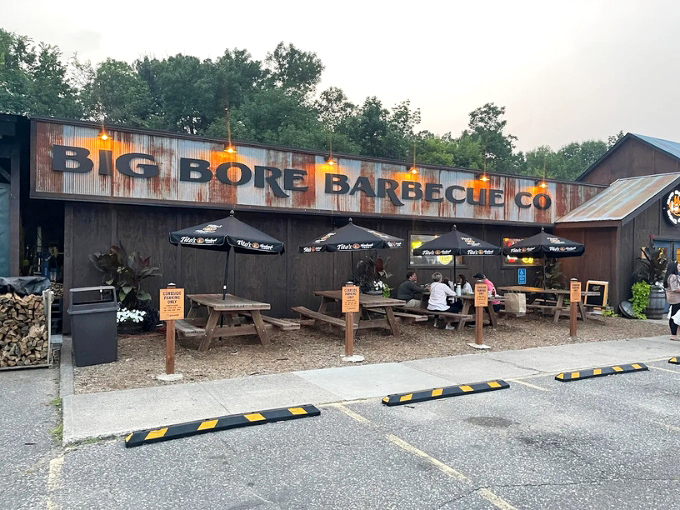 Rustic charm meets smoky perfection at Big Bore Barbecue's weathered exterior, where culinary magic happens behind unassuming walls.