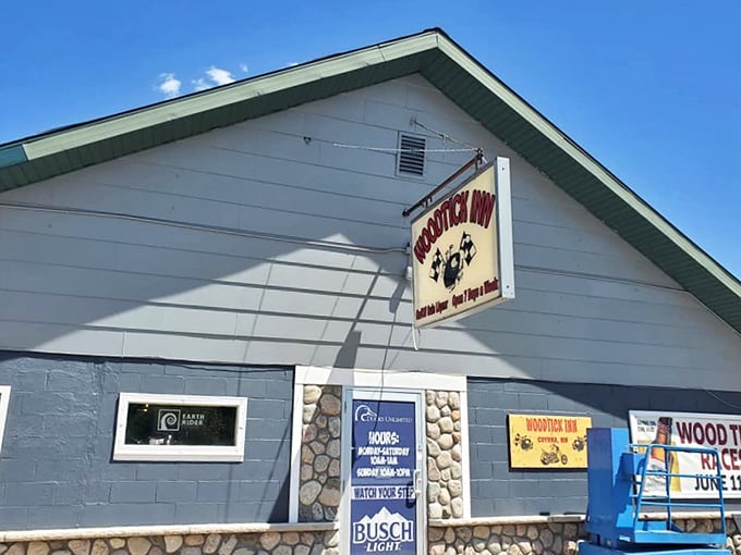 The Woodtick Inn's iconic sign promises year-round hospitality with its racing tick mascot &ndash; a quirky beacon for thirsty travelers.