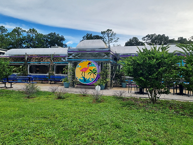 The gleaming silver exterior of Pink Flamingo Diner catches Florida sunshine like a time-traveling spaceship that landed with perfect timing for lunch.