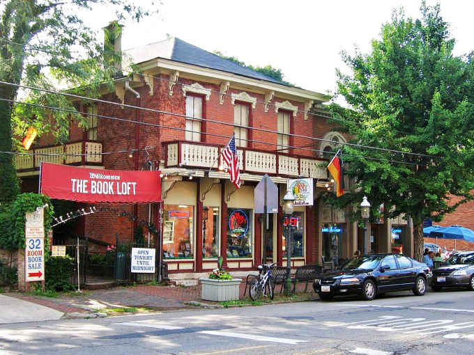The iconic red-brick facade of The Book Loft stands proudly in German Village, its crimson awnings beckoning bibliophiles like a literary lighthouse.