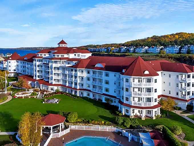 Grand white architecture with distinctive red roofs creates a striking first impression against Michigan's brilliant blue skies and crystal waters.