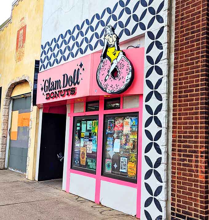 The iconic pink storefront of Glam Doll Donuts stands out like a retro dream in Minneapolis, beckoning sweet-toothed adventurers with its pin-up girl logo.