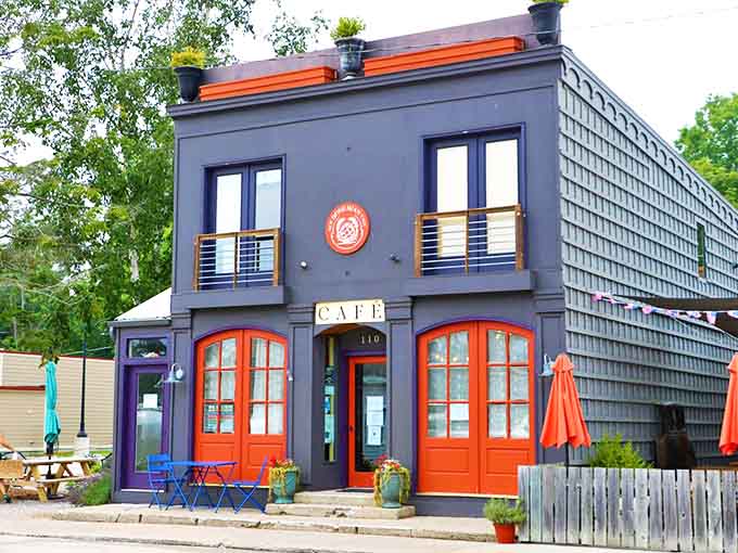 The New Bohemian Caf&eacute;'s striking gray exterior with vibrant orange doors stands like a culinary lighthouse in Northport, beckoning breakfast enthusiasts from miles around.