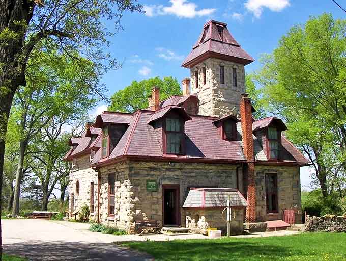 Mac-A-Cheek Castle stands proudly against the Ohio sky, its limestone walls and distinctive red roof creating a fairytale vision in the most unexpected location.