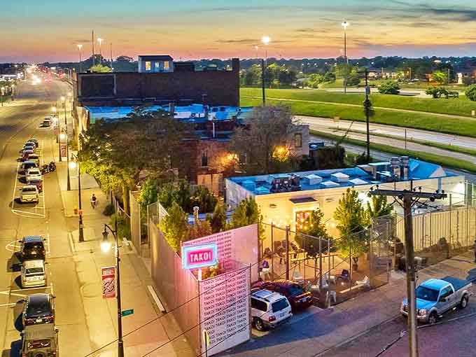Takoi's exterior glows like a neon beacon in Detroit's Corktown, promising culinary adventures behind that illuminated sign.