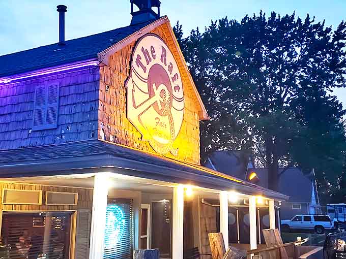 The Raft's illuminated sign glows like a lighthouse beacon for hungry travelers, promising nautical charm and mouthwatering delights just steps from Lake St. Clair.