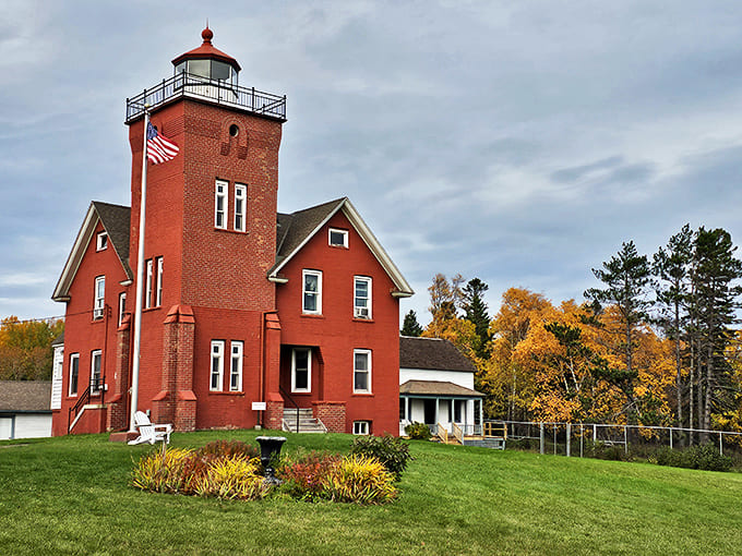 The iconic red brick Two Harbors Lighthouse stands proudly against Minnesota skies, beckoning travelers with its historic charm and lakeside serenity.
